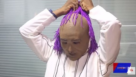 Anas takes off his beaded mask to reveal his face... or does he?